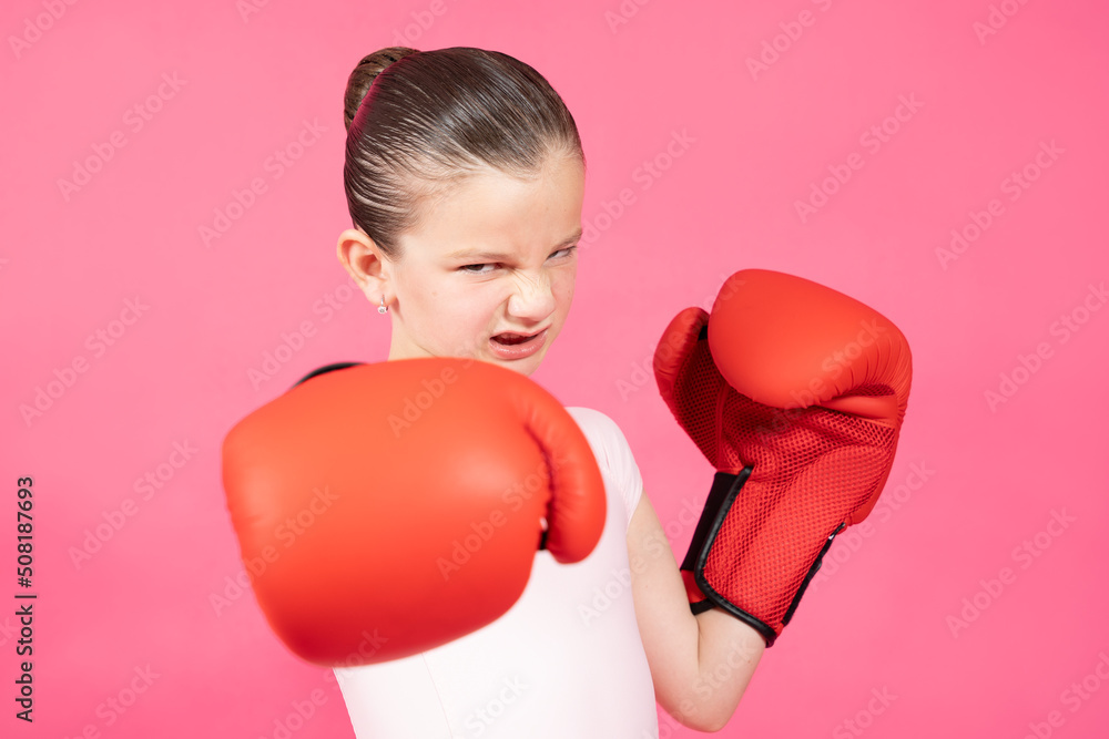 Little girl menacing and prepared to fight while looking at camera ...