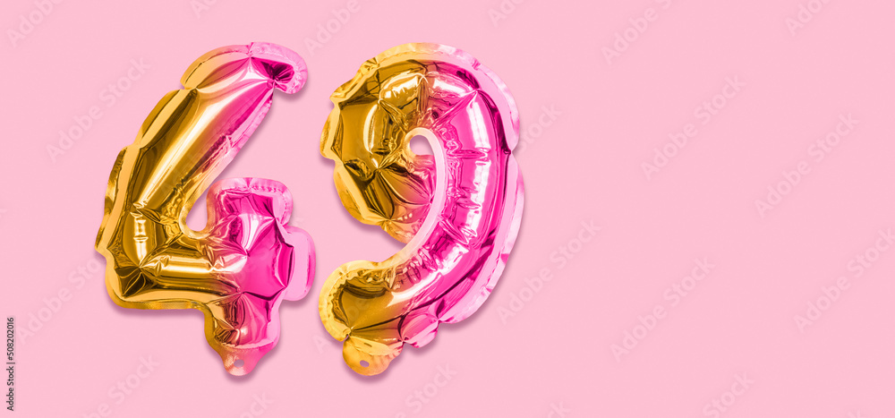 Rainbow foil balloon number, digit forty nine on a pink background ...