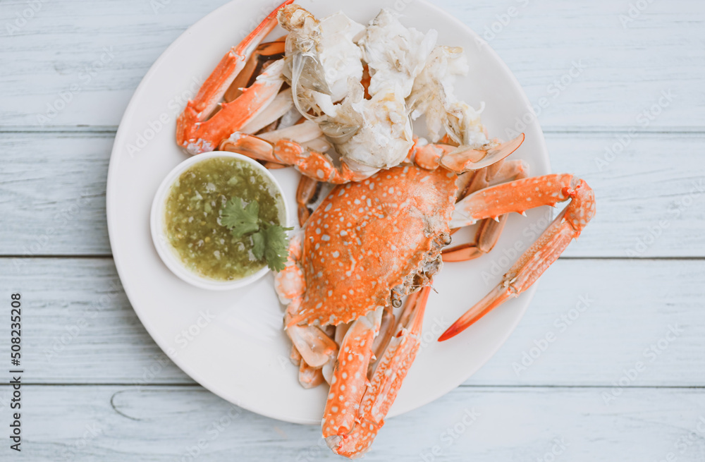 seafood plate fresh crab cooking on white plate background , blue ...