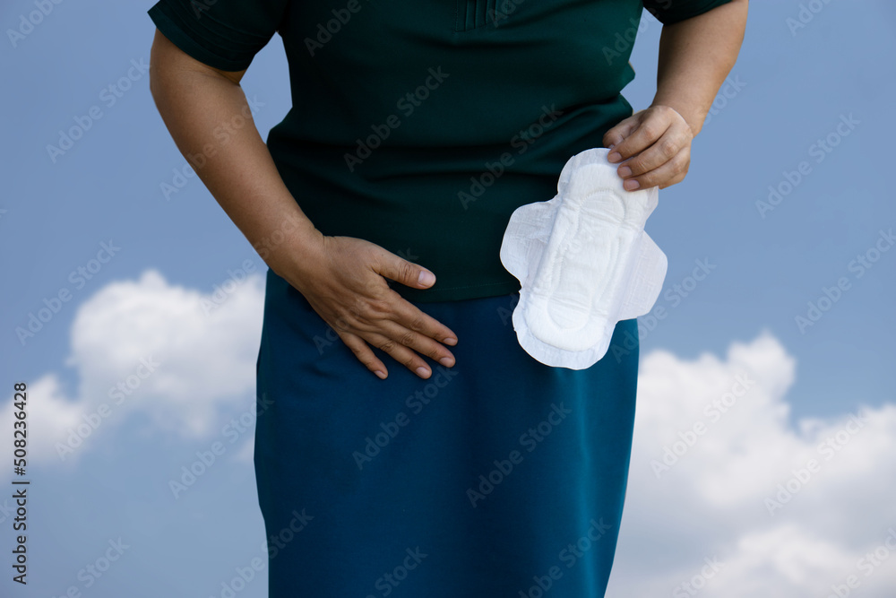 Woman holds sanitary pads, feel pain menstruation. Concept: female's ...