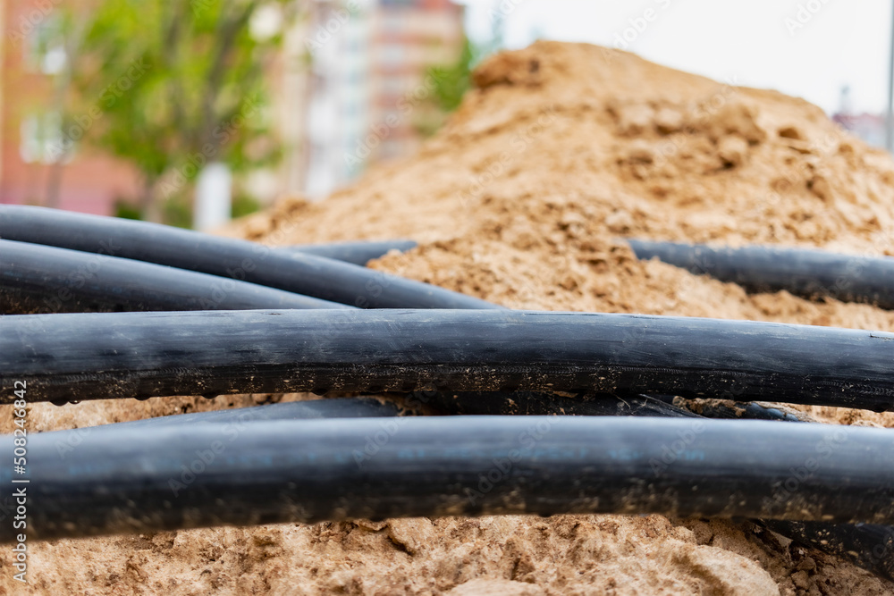 The high voltage electrical cable is laid in a trench. Close-up of an ...