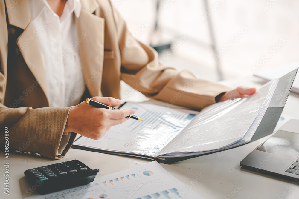 business woman or accountant who are using a calculator to calculate ...