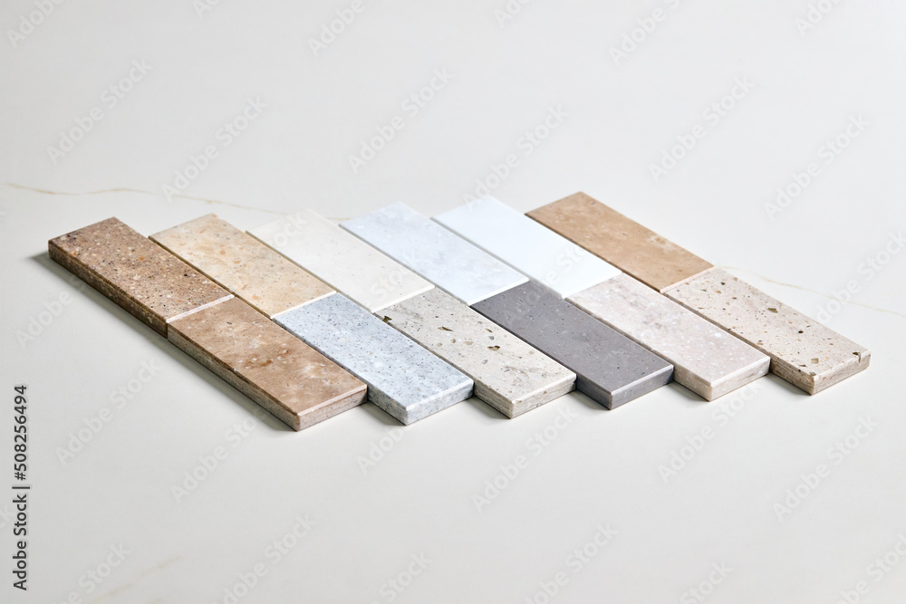 Porcelain ceramic stoneware samples laid on kitchen stoneware table as ...