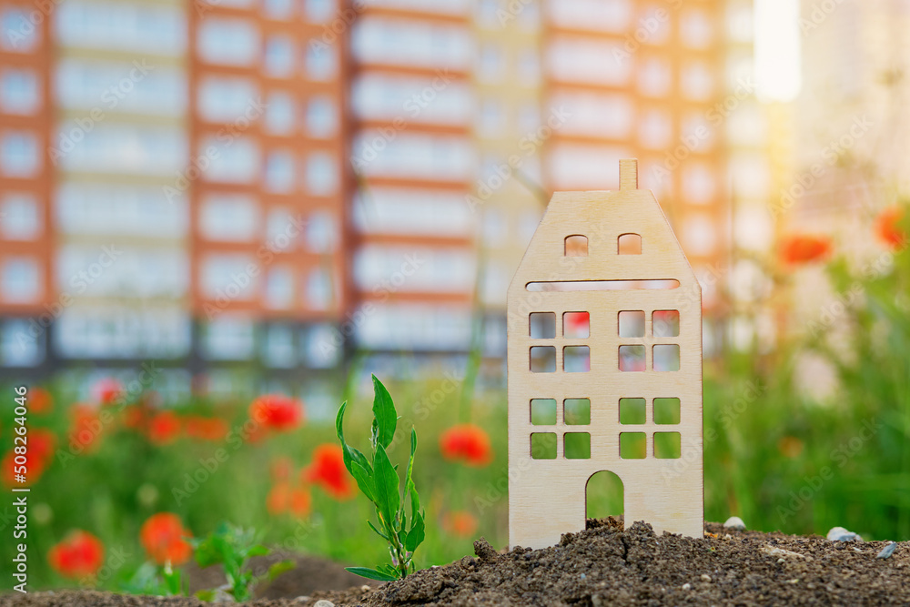 a model of a multi-storey building against the background of a real ...