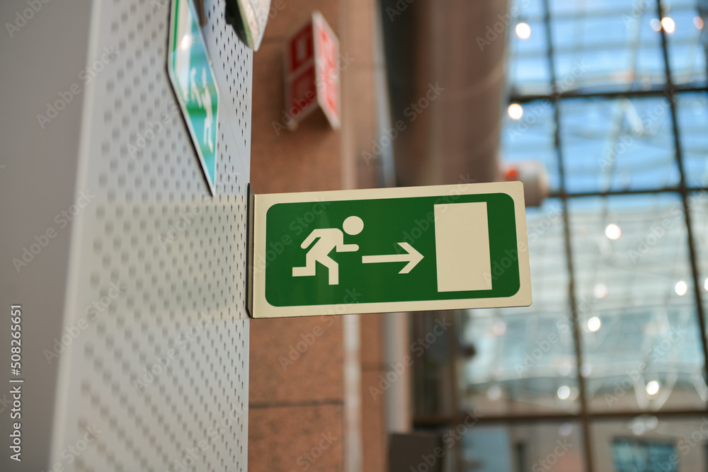 Emergency exit sign inside a conference building. Detail photo of the ...