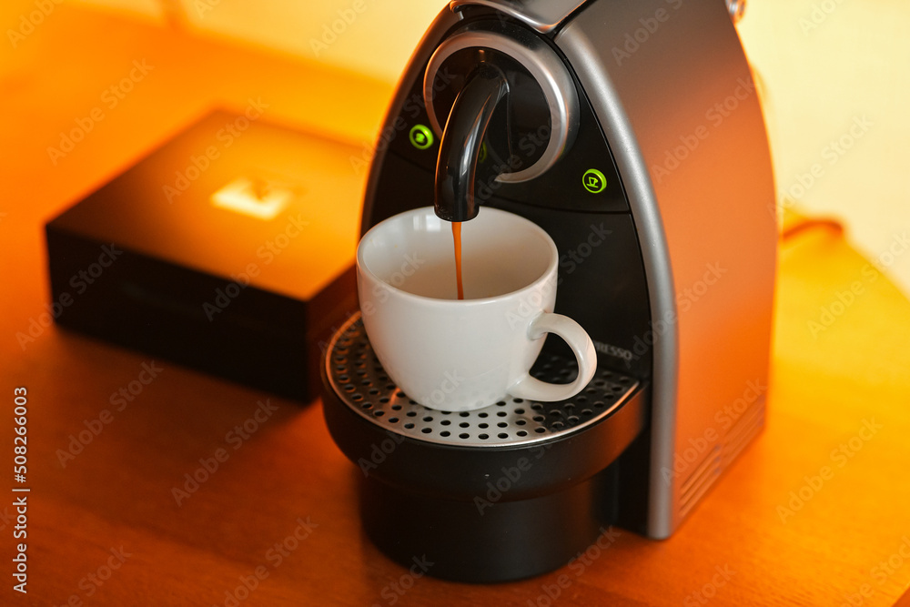 Nespresso Essenza coffee machine preparing an espresso coffee on a ...