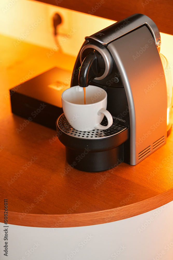 Nespresso Essenza coffee machine preparing an espresso coffee on a ...