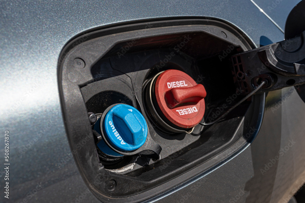 Fuel filler flap open with red diesel cap and blue adblue, the fuel ...