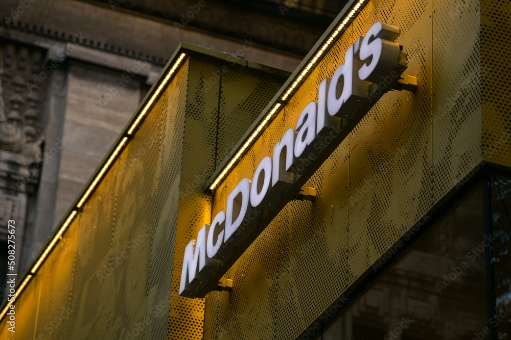 The logo sign of McDonalds American fast-food chain on top of a ...