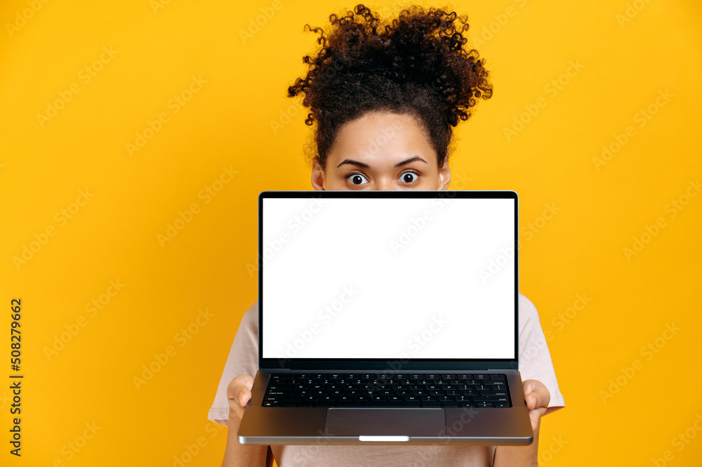 Amazed excited brunette african american girl peeking out from behind ...