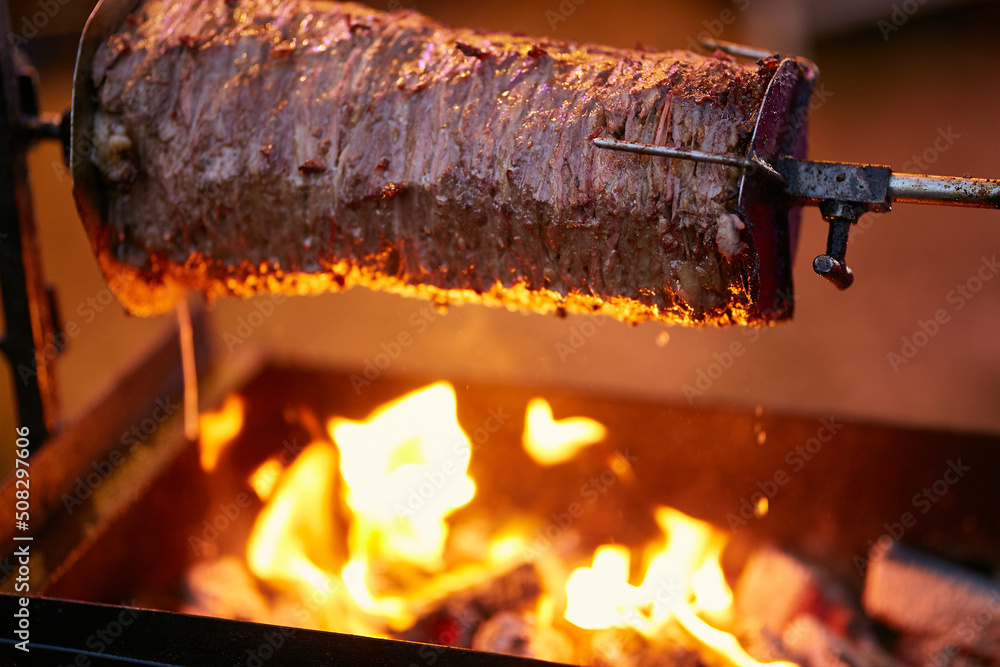 shawarma, lamb on a spit. street food. Doner Kebab on a rotating spit ...