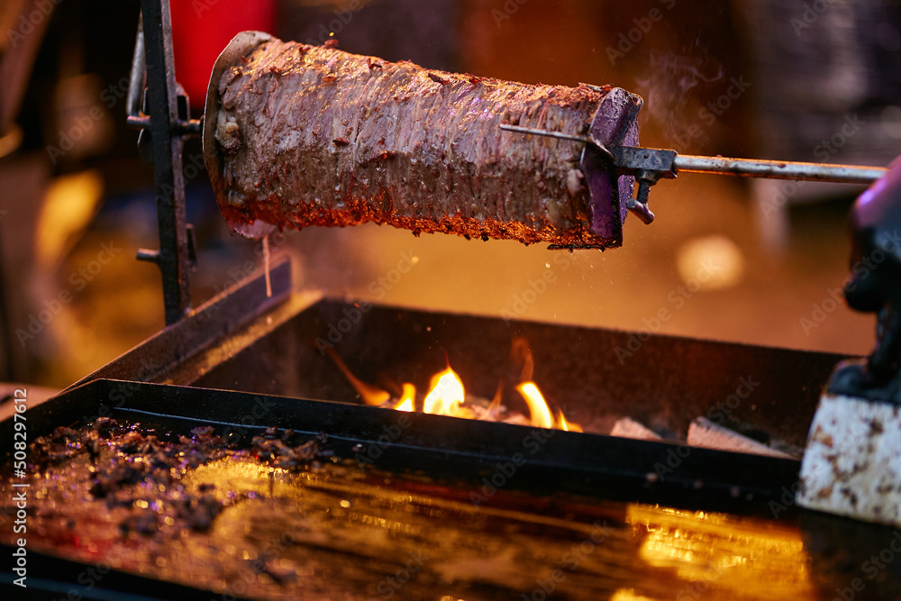 shawarma, lamb on a spit. street food. Doner Kebab on a rotating spit ...