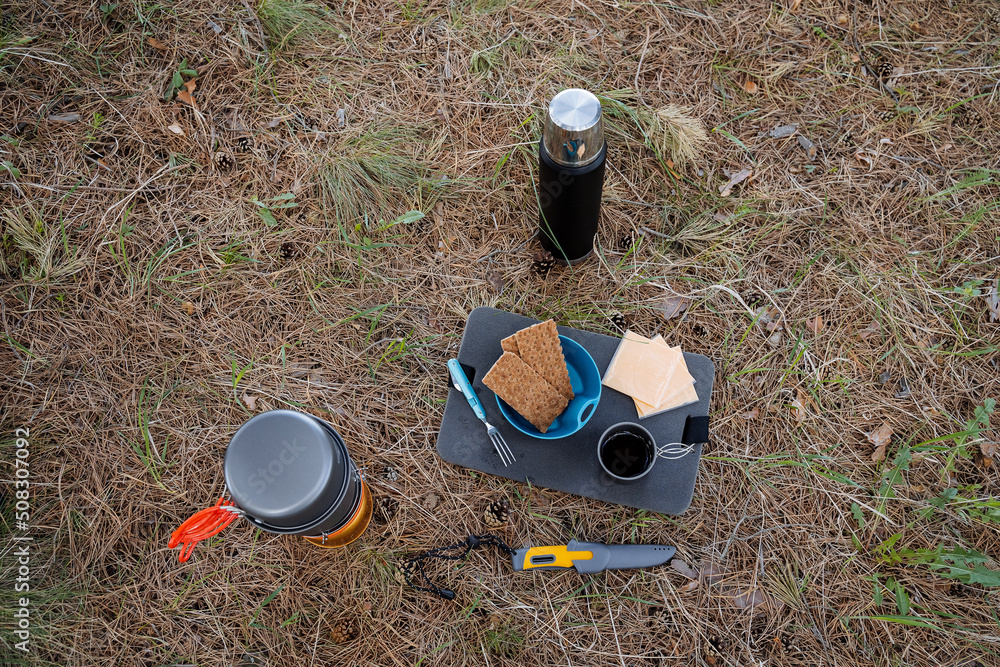 Camping food in nature lies on the ground, top view of tourist food on ...