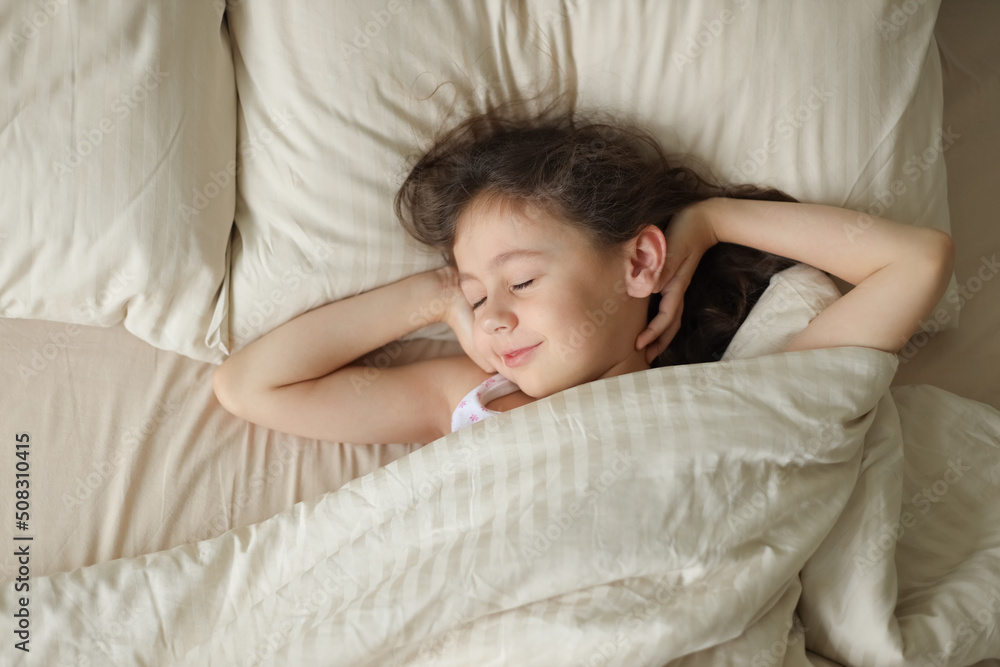 Cute girl sleeping in bed Stock Photo | Adobe Stock