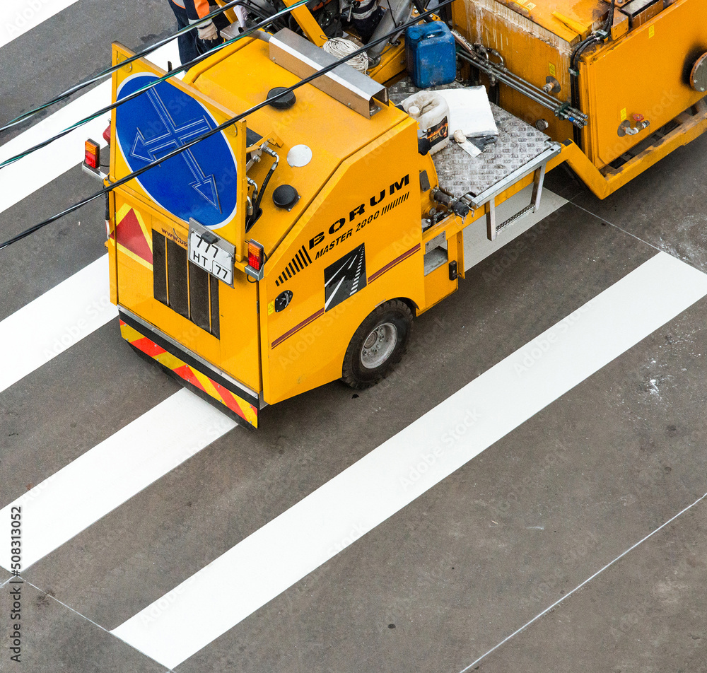 the line marking AI robotic big machine, painting a zebra marking on a ...