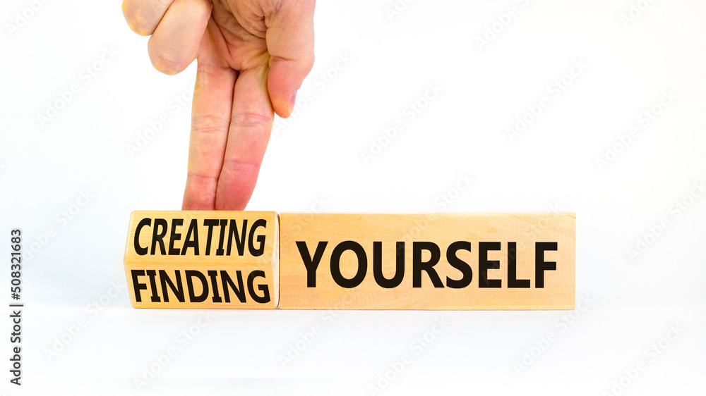 Finding or creating yourself symbol. Businessman turns wooden cubes and ...