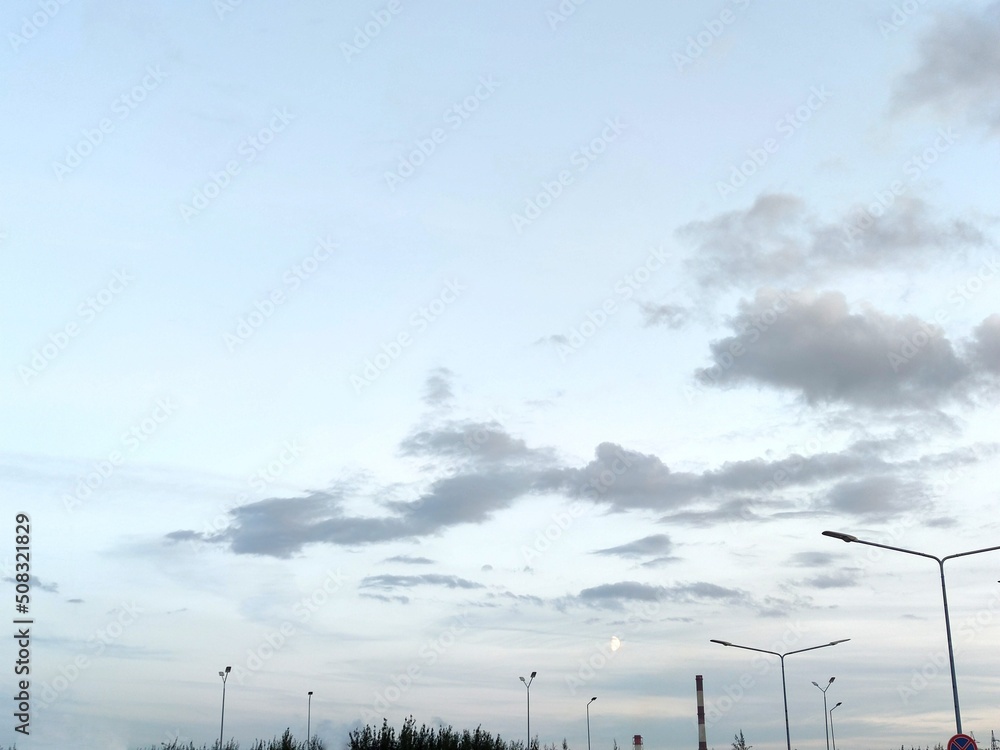 Light blue sky with clouds. Above high lanterns under a light blue sky ...