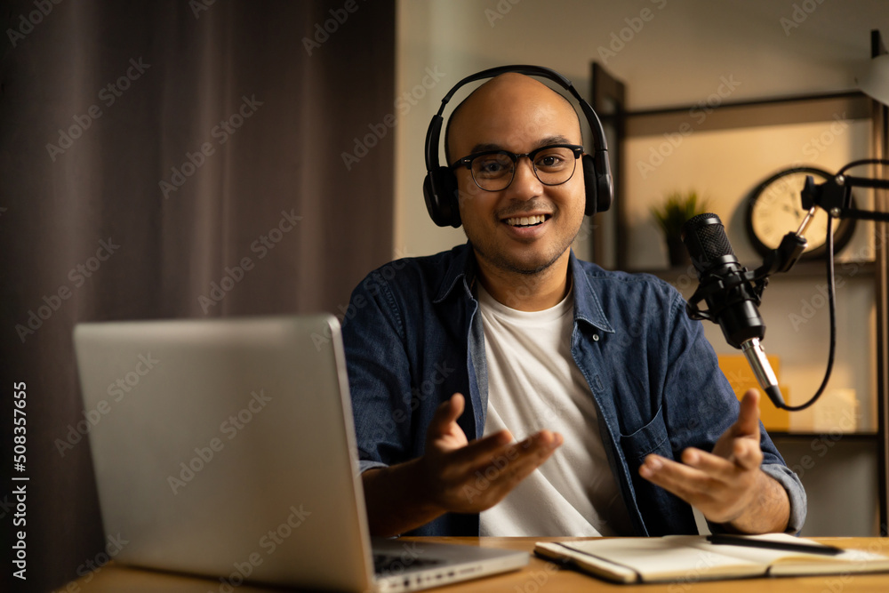 Young asian man host streaming podcast with condenser microphone work ...