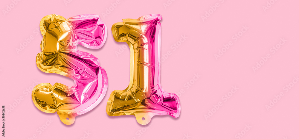 Rainbow foil balloon number, digit fifty one on a pink background ...