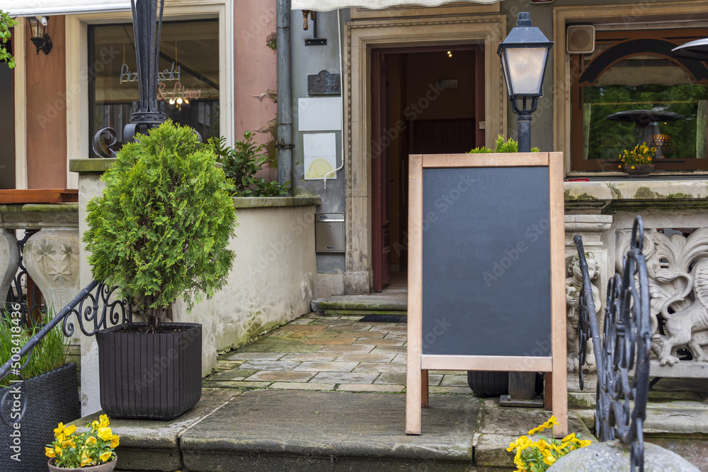 Blank restaurant shop sign or menu board near the entrance to ...