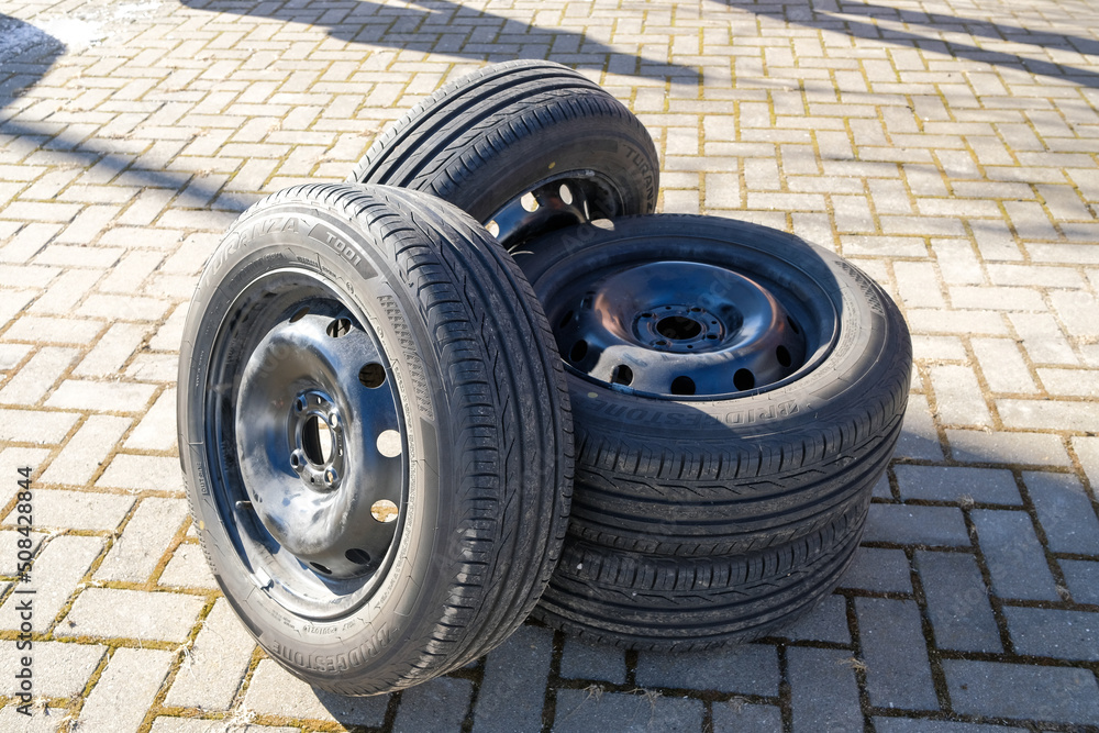New set of summer tires stacked on the pavement. Bridgestone Turanza ...