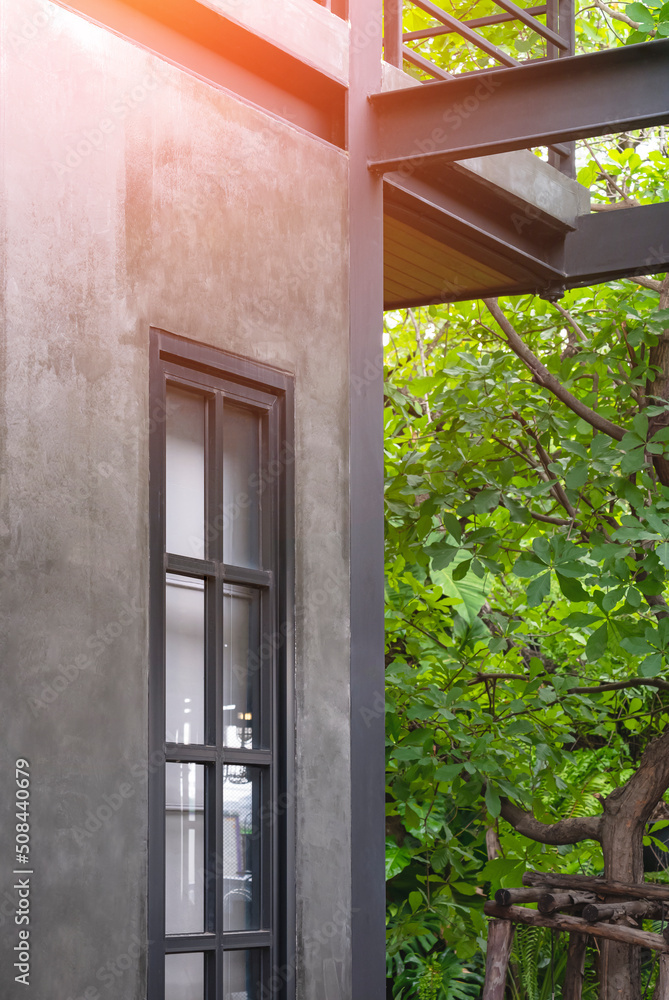 Side view of glass window on cement wall of vintage house in industrial ...