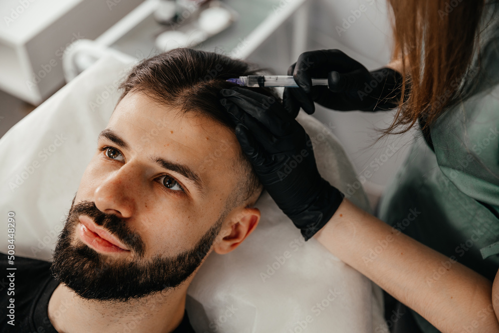 Mesotherapy. Injections with vitamins for hair growth on bald parts of ...