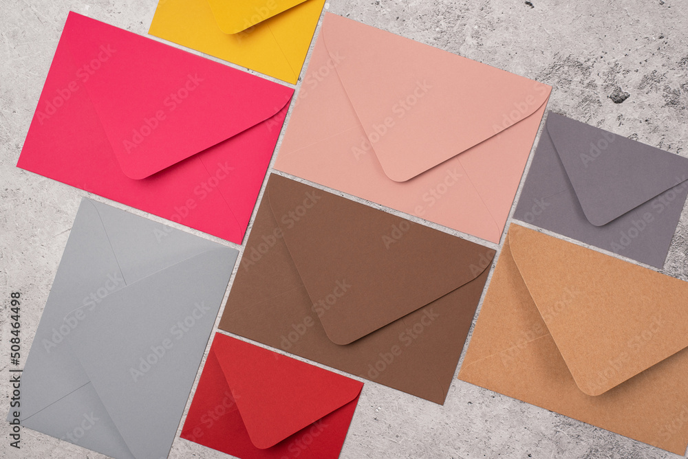 Envelopes of a different size and color on a light concrete background ...