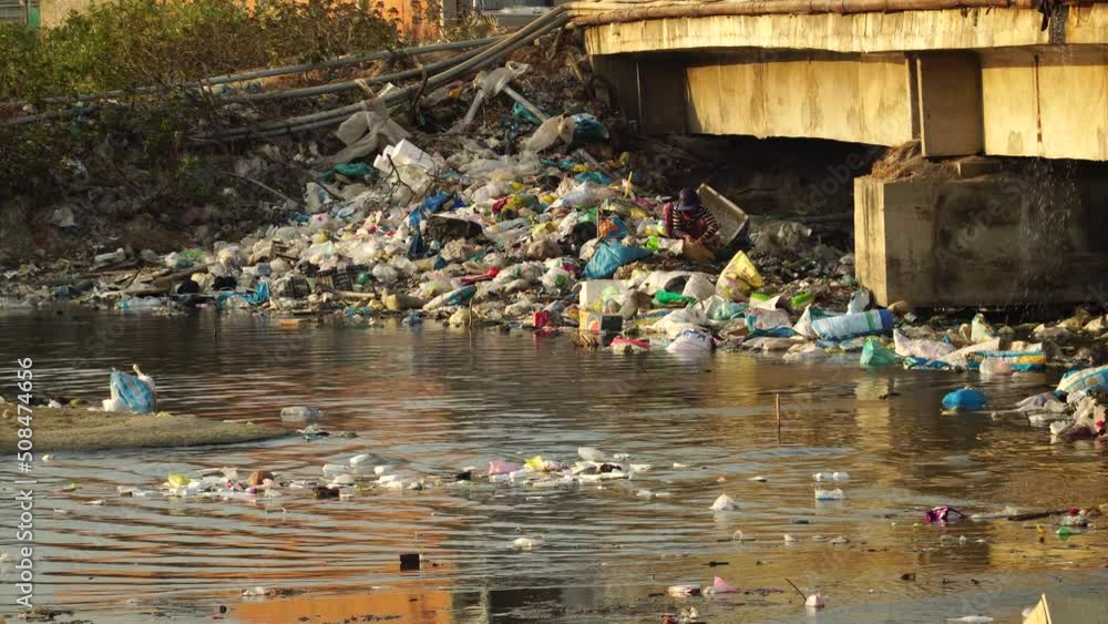 A Local In Son Hai, Vietnam Scavenge The Pile Of Garbage In The ...