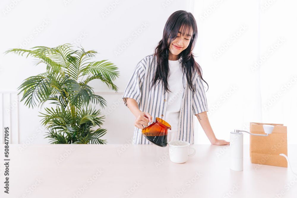 Asian professional woman barista with black long hair, hand pouring ...
