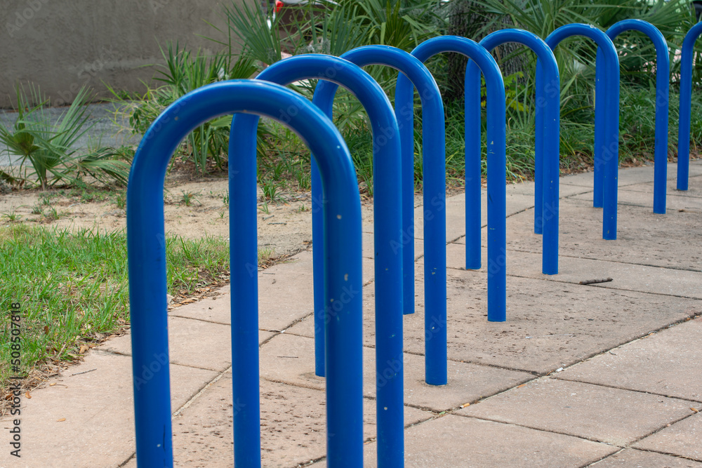 Large blue metal bicycling hub racks. The curved wave shape of the ...