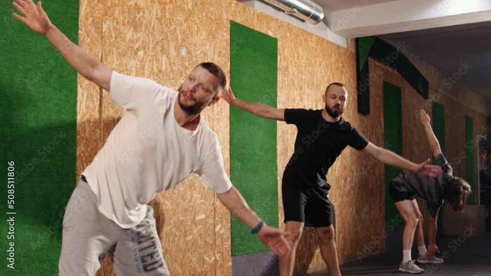 Young mean business workers in healthy tilt arm and back pose ...