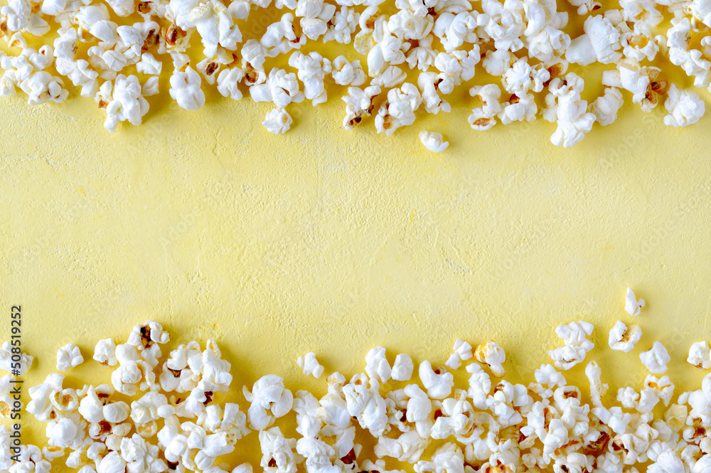 Popcorn background. Air corn frame. Opened corn grains on a yellow ...