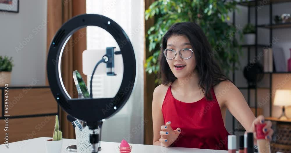 A popular influencer vlogger creates a video on social media talking ...