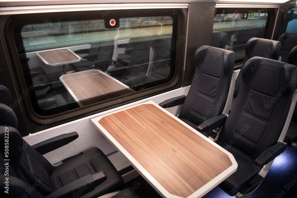 Empty comfortable modern seats inside business class cabin of fast ...