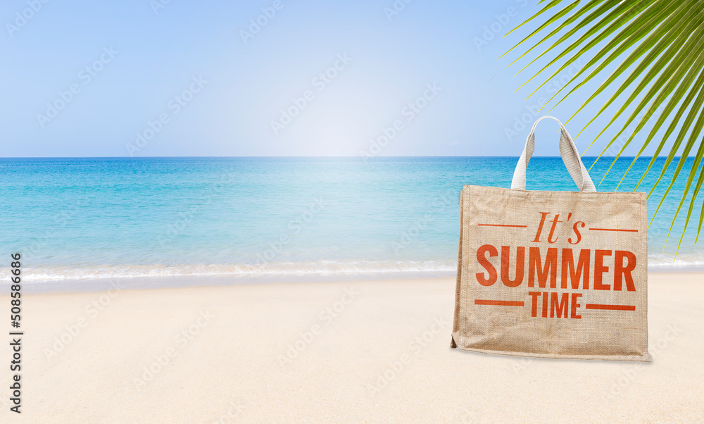 Jute bag on tropical summer beach background, it's summer time banner ...