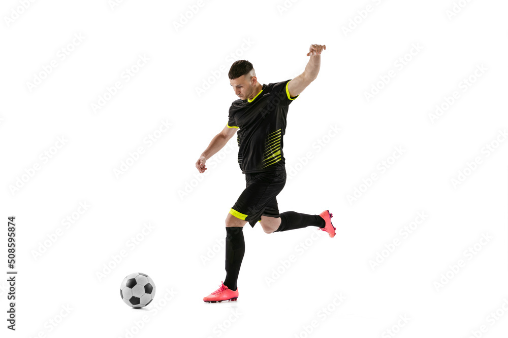 Professional male football soccer player in motion and action isolated ...