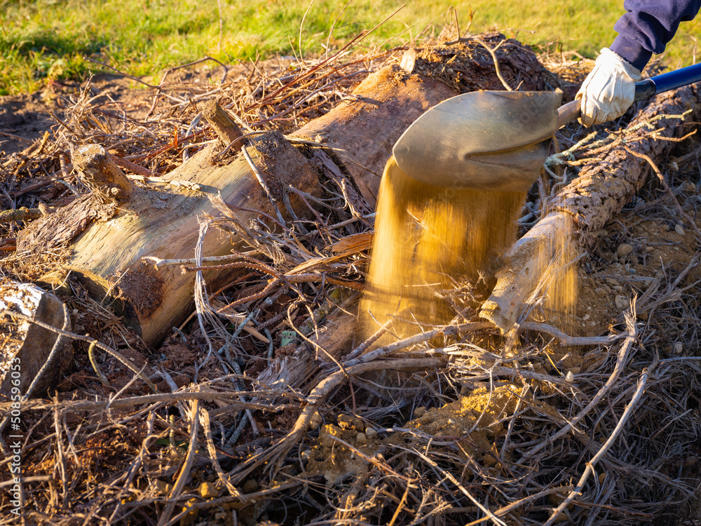 Adding soils on top of the Logs, Branches, and Compost Piled Up for ...