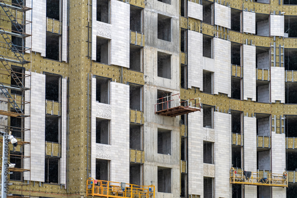 Monolithic concrete frame of apartment building under construction with ...