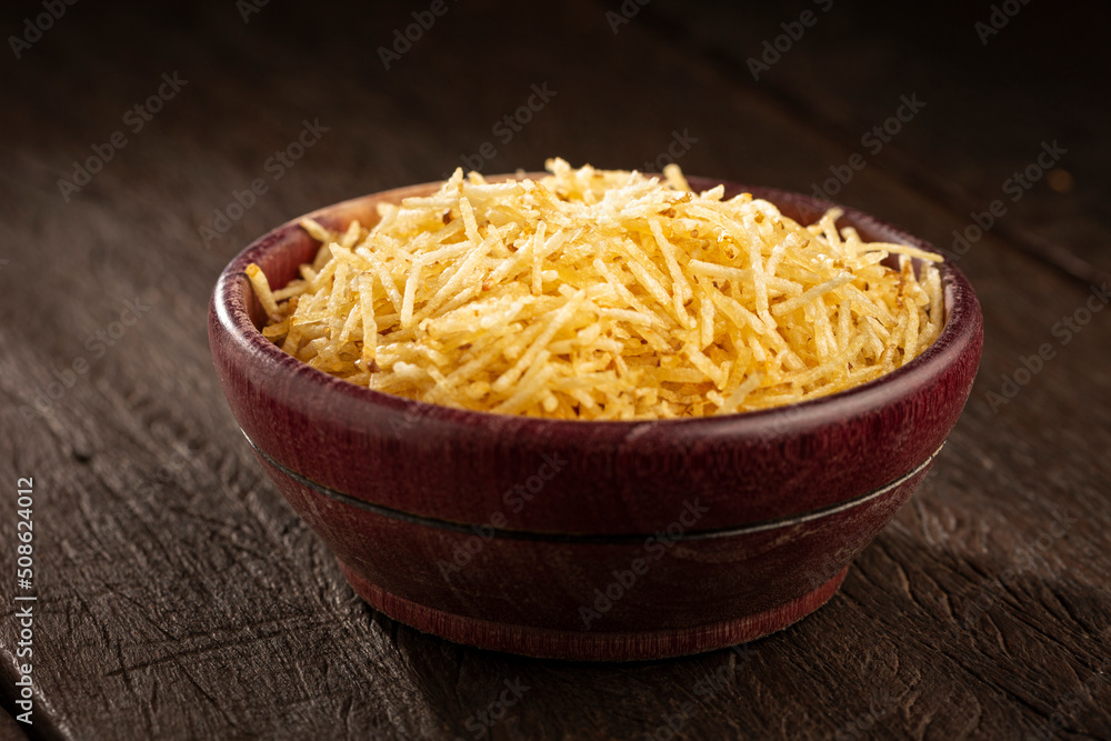 Straw potatoes in a bowl on the table. Stock Photo | Adobe Stock