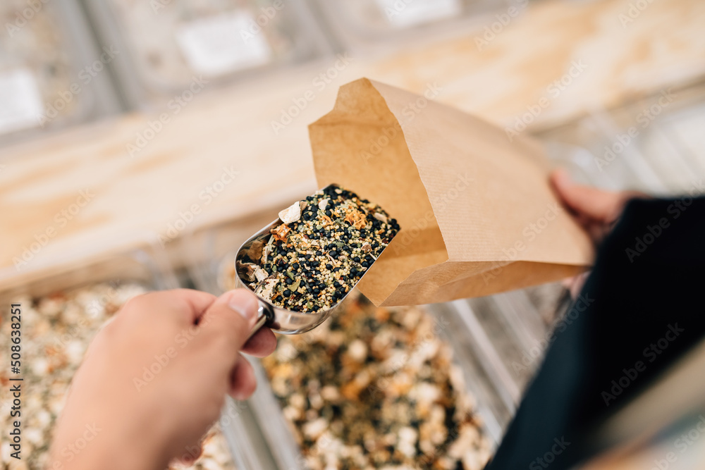 Person putting spices inside paper bag Stock Photo | Adobe Stock