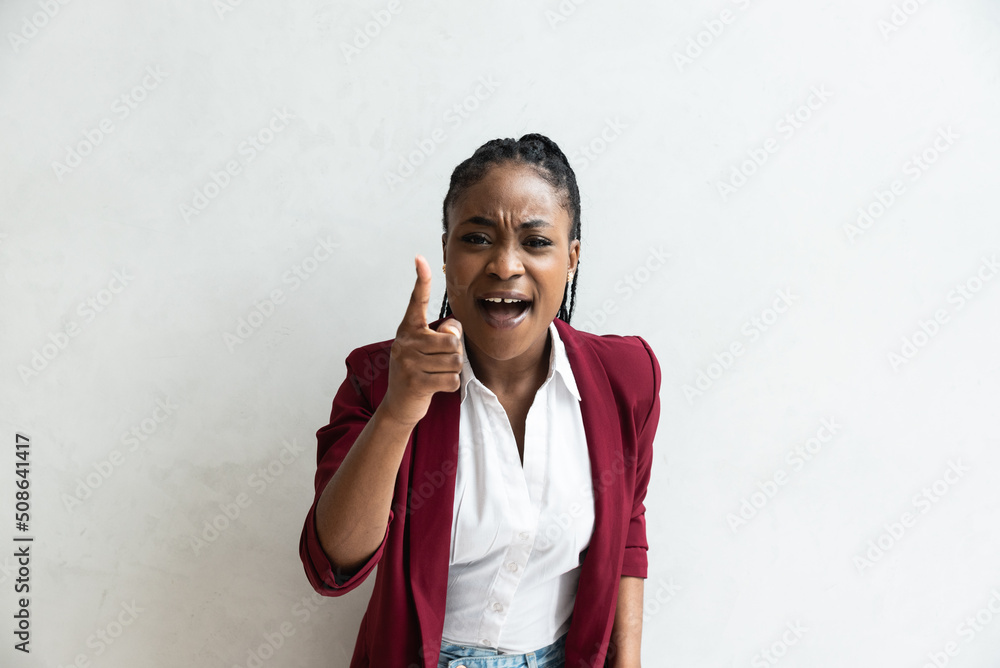 Foto de Young business woman point finger screaming of anger and ...