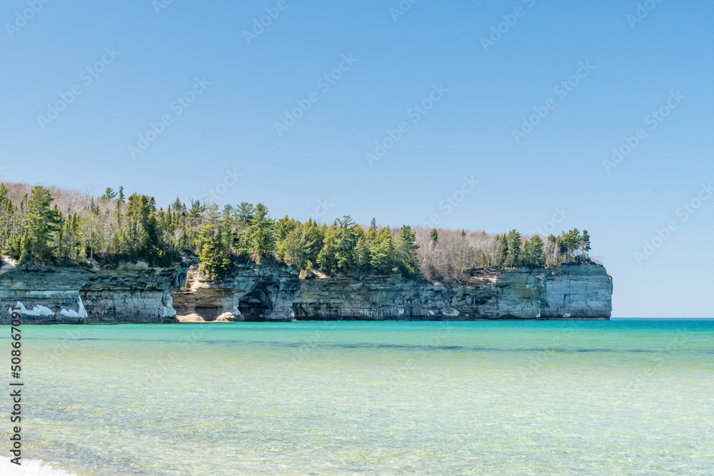 The Lake Superior lakeshore and the tree covered cliffs of Pictured ...