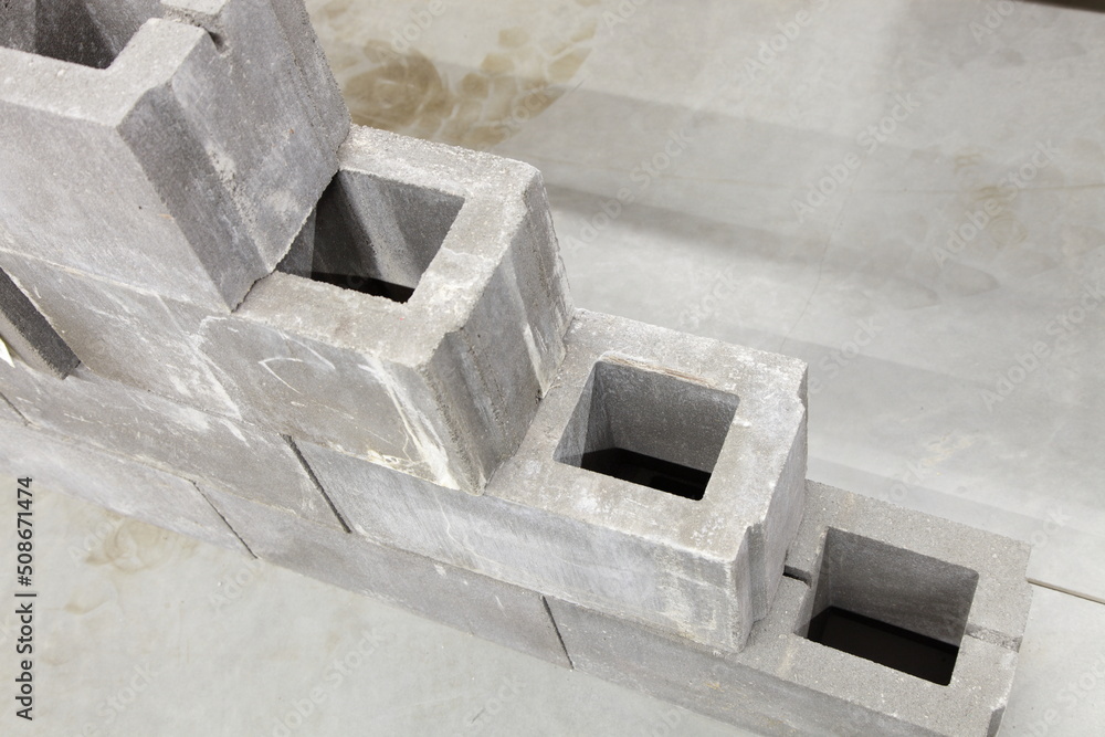 New gray concrete ventilated wall blocks close up in stack. Building ...