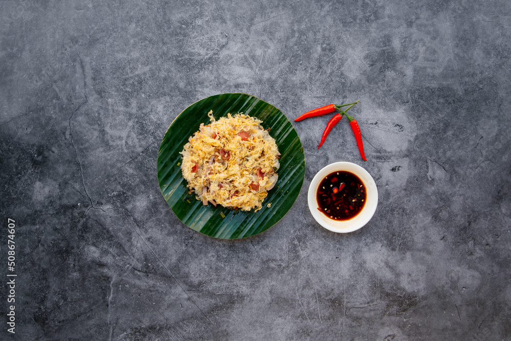 Mixed Sticky Rice, salad and fish sauce served in bowl isolated on dark ...