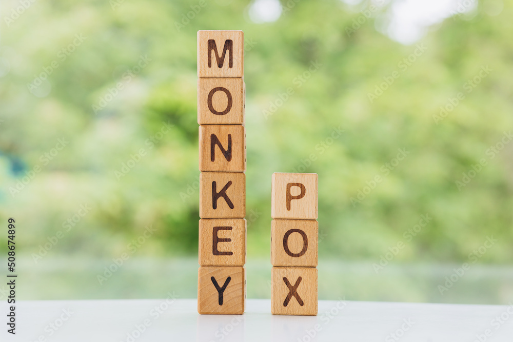 MONKEYPOX. Word written on square wooden tiles with an green background ...