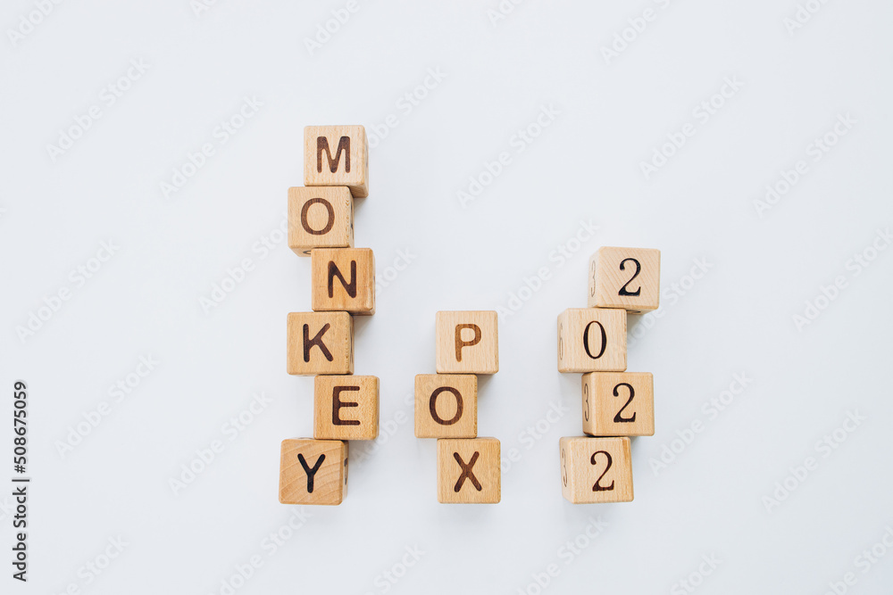 MONKEYPOX. Word written on square wooden tiles with an white background ...