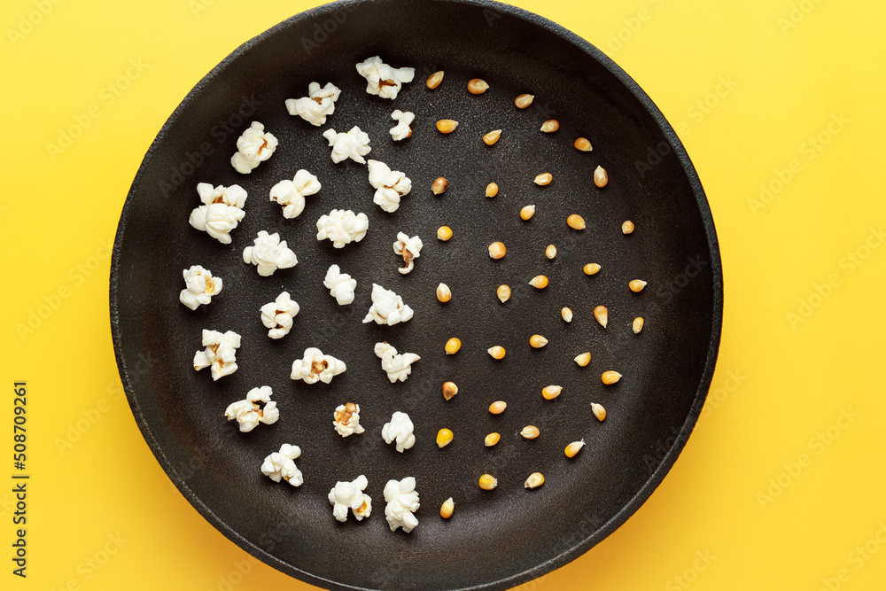 Popcorn in a black pan without a handle, half a pan of corn grains ...