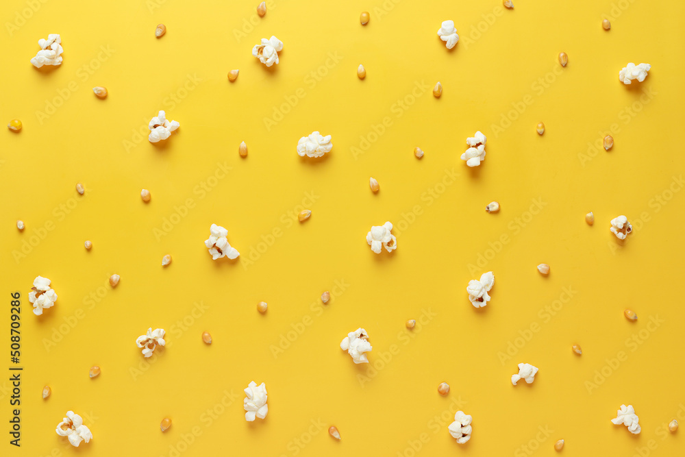 Popcorn and corn kernels are randomly arranged on a yellow background ...