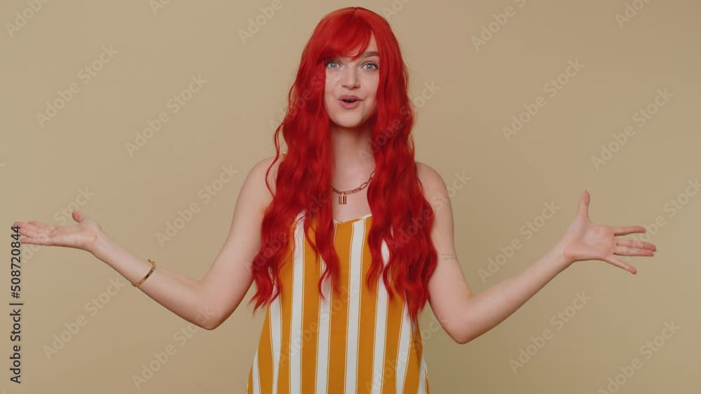 Excited amazed ginger woman in tank top touching head, showing ...